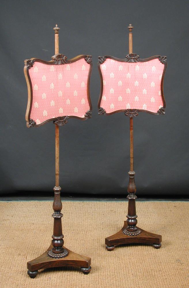 Lot 937 - A pair of late Regency rosewood pole screens,