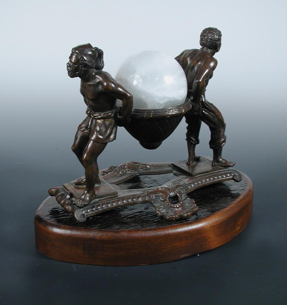 Lot 818 - A bronze basket supported by two Nubians,