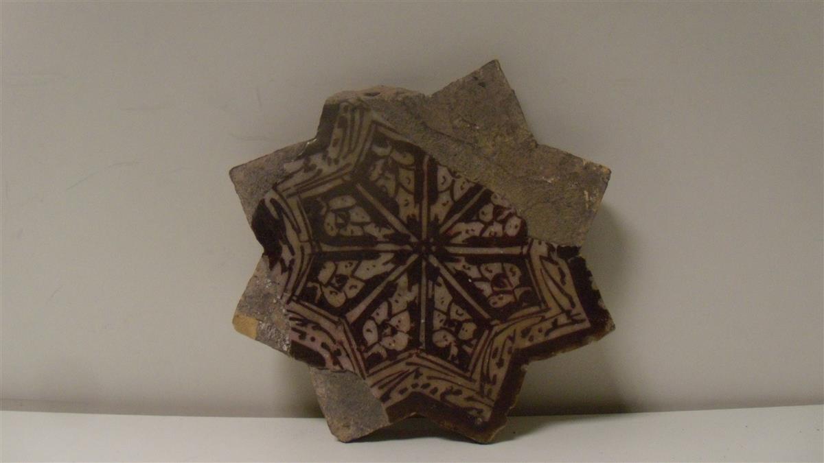 Lot 21 - A 14th century Islamic Persian star tile,