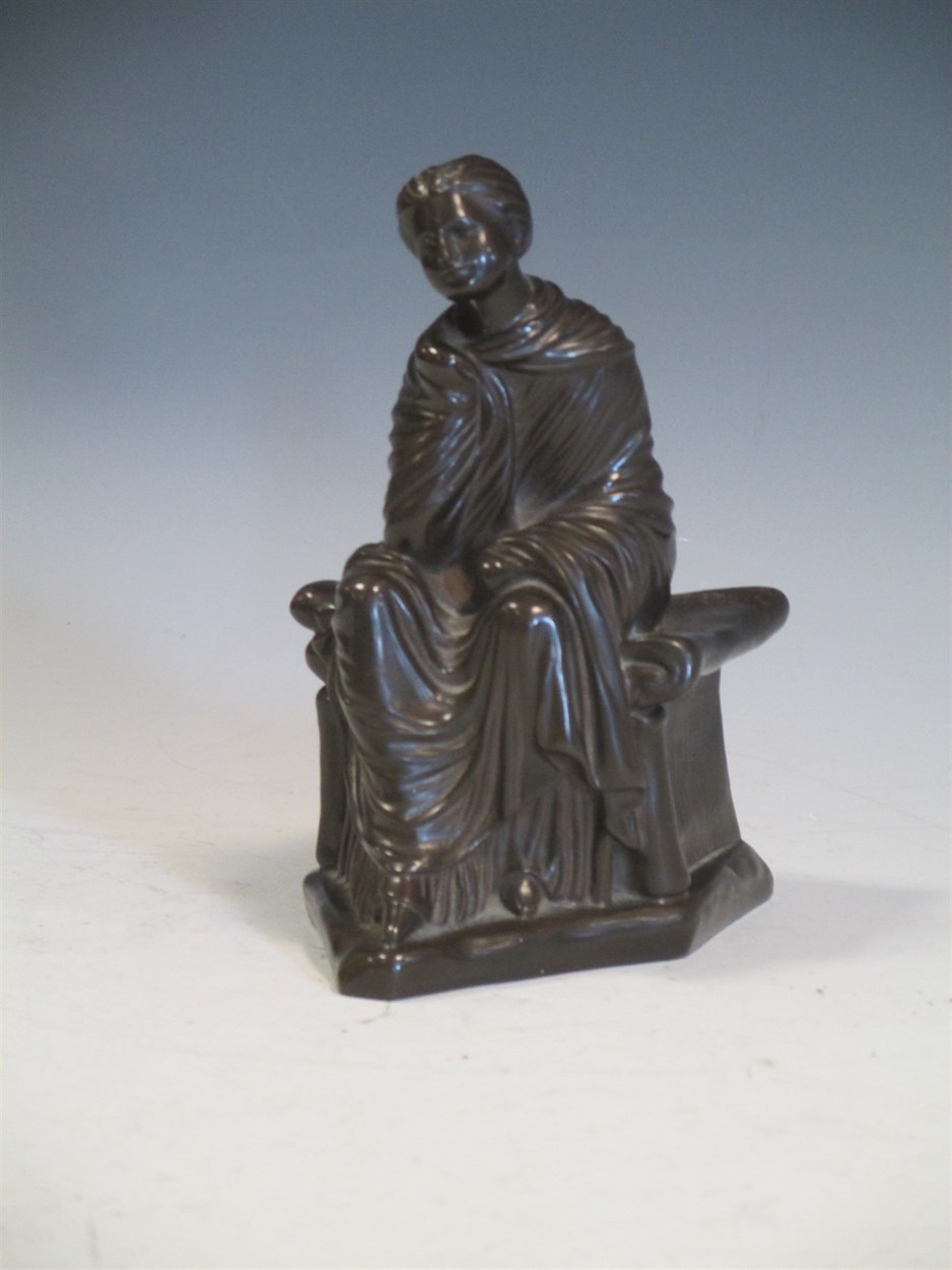 Lot 6 - A small bronzed seated lady