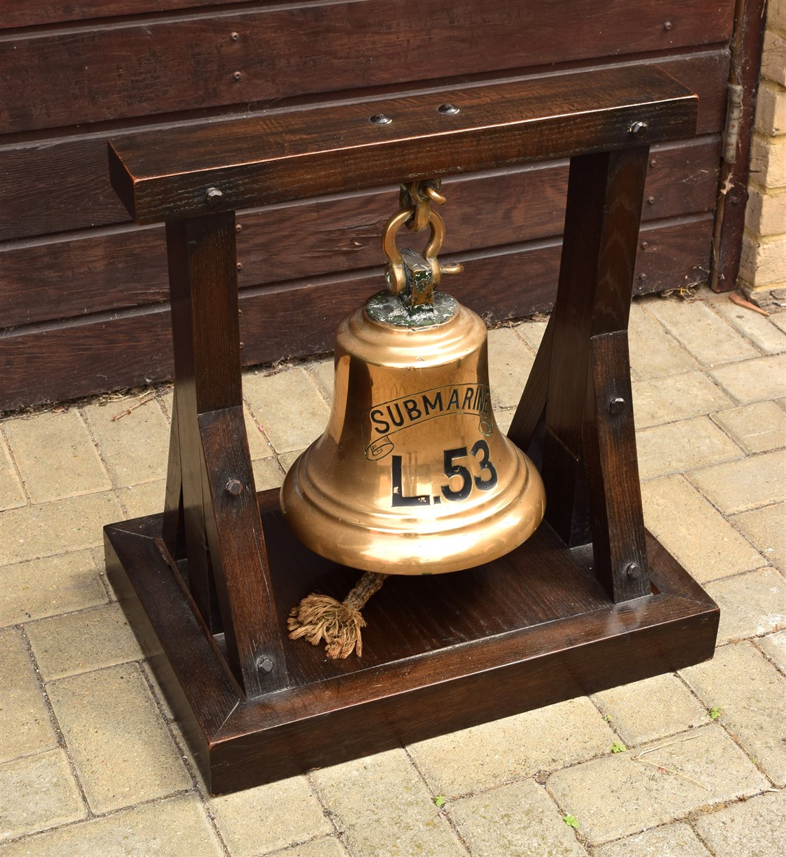 Lot 658 - A brass submarine bell on a wooden stand,
