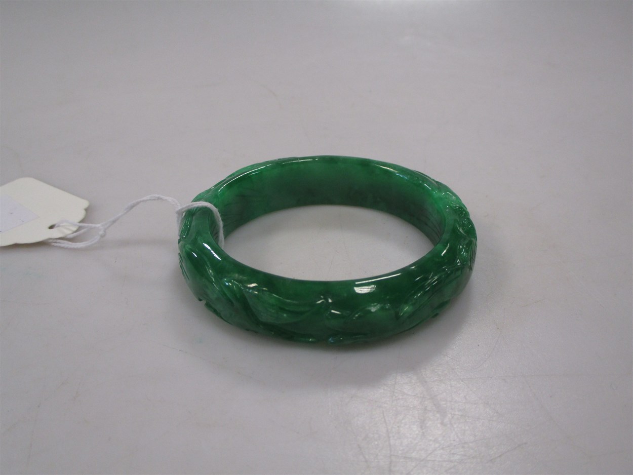 Lot 266 - A carved jade bangle