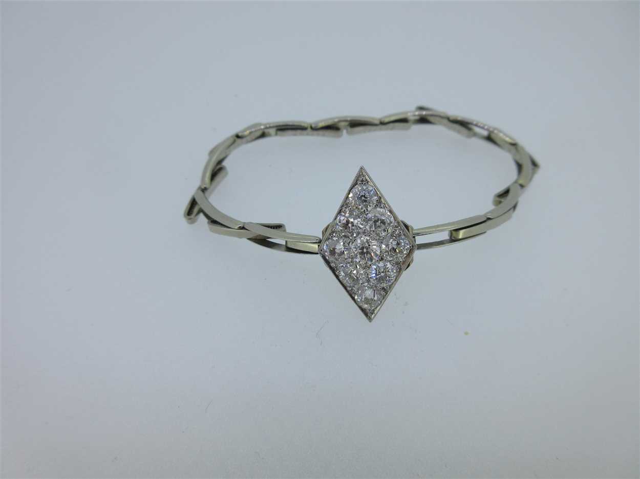 Lot 259 - A diaper form diamond plaque set into an