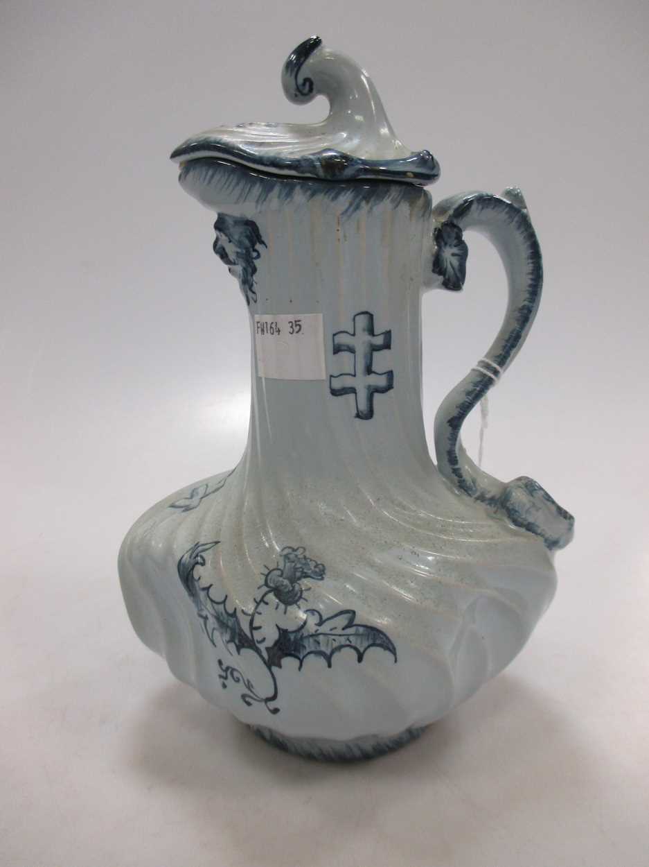 Lot 49 - A Galle blue mask jug and cover, of moulded
