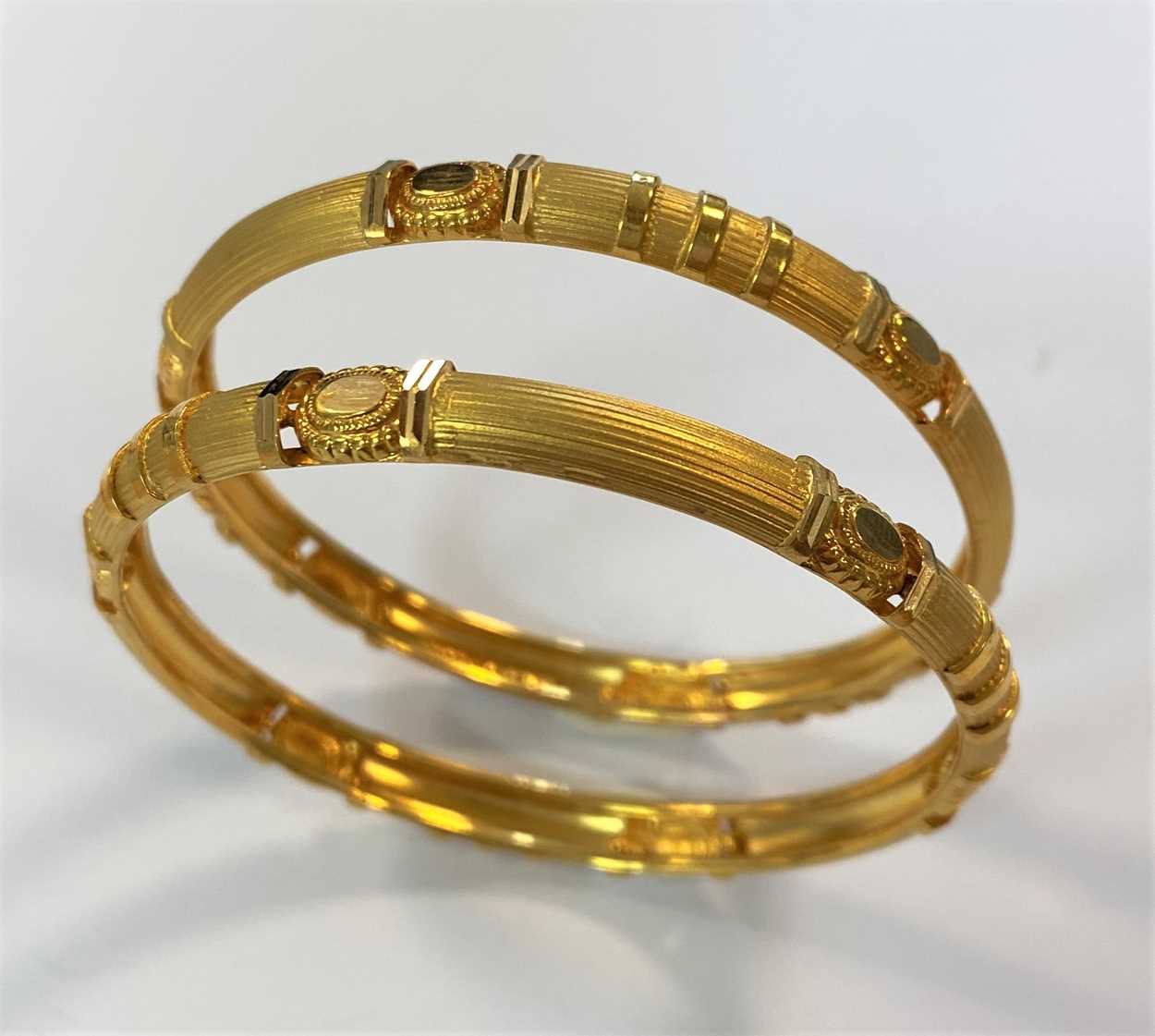 Lot 71 - A pair of Indian kada bangles,