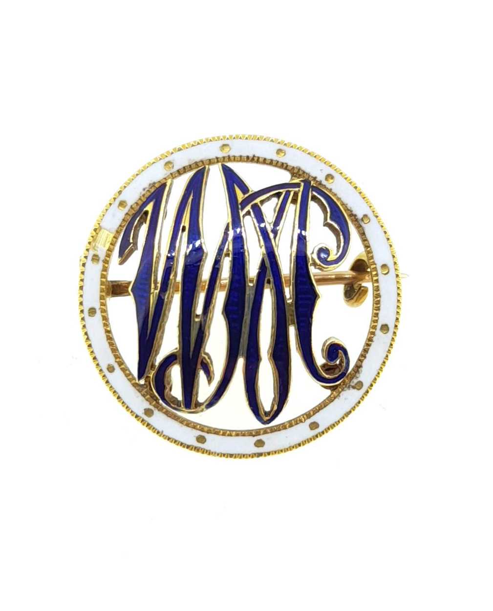 Lot 78 - A circular enamelled monogram brooch,