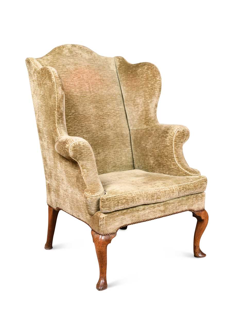 Lot 141 - A walnut wing back arm chair, 18th century,