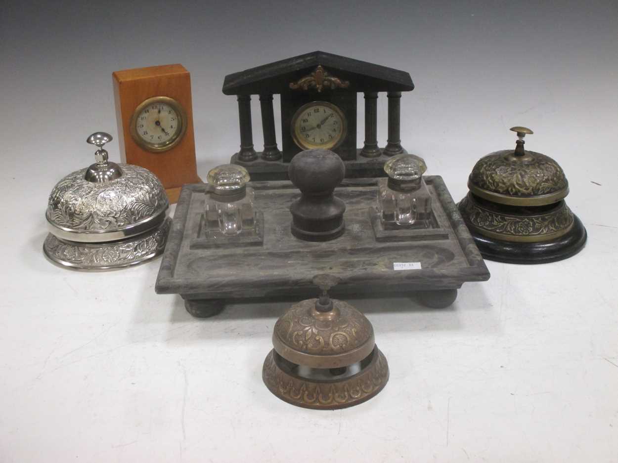 Lot 56 - Three metal counter bells, a stone desk tray