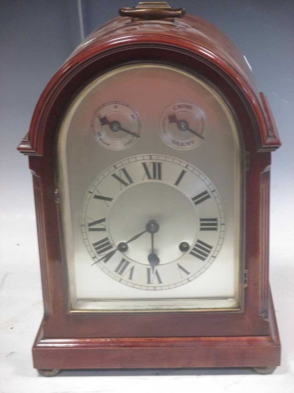 Lot 356 - A dome top mahogany chiming table clock with