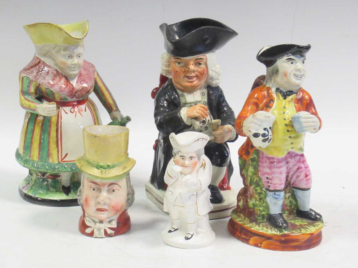 Lot 72 - A 19th century toby modelled as woman holding