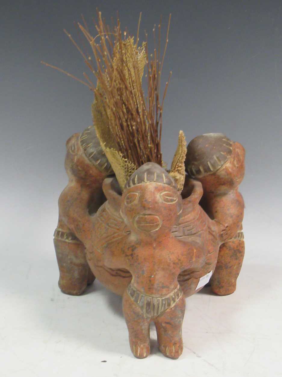 Lot 133 - A three handled terracotta pot with the