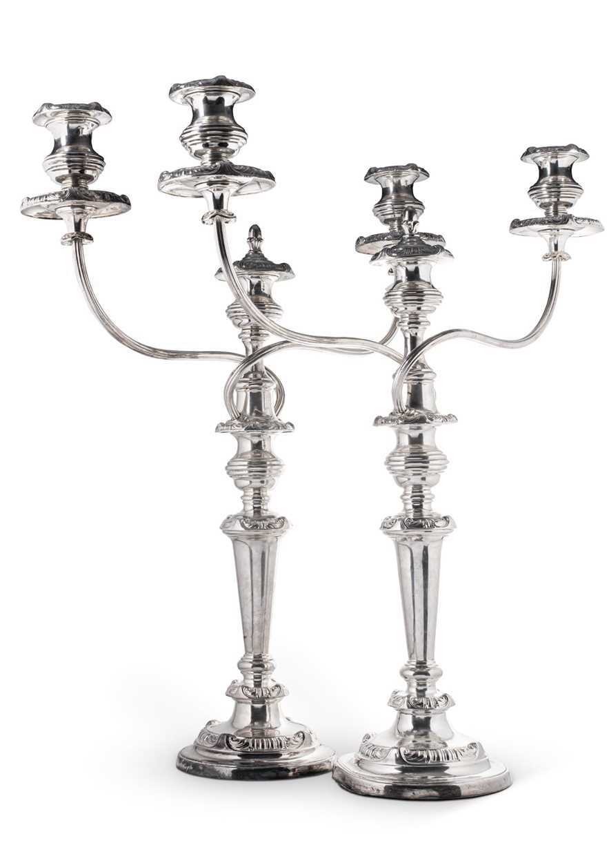 Lot 555 - A pair of George III silver candlesticks