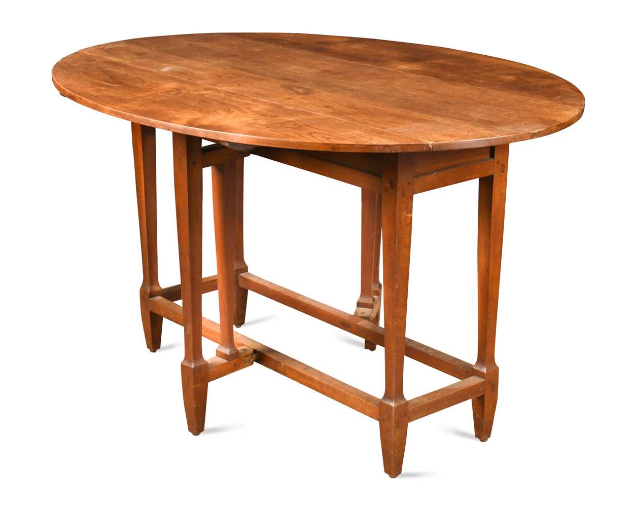 Lot 205 - An Arts & Crafts oak drop-leaf dining table,