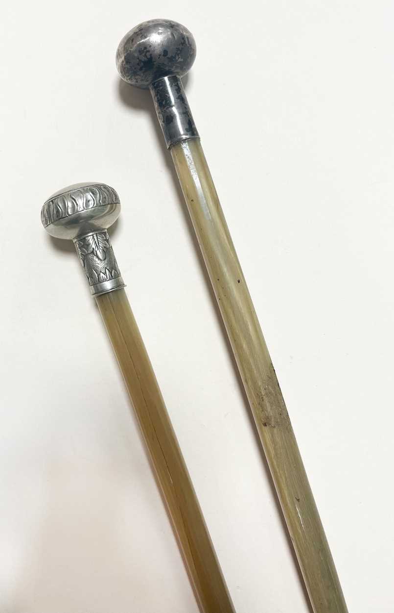 Lot 69 - Two White metal mounted horn riding crops,