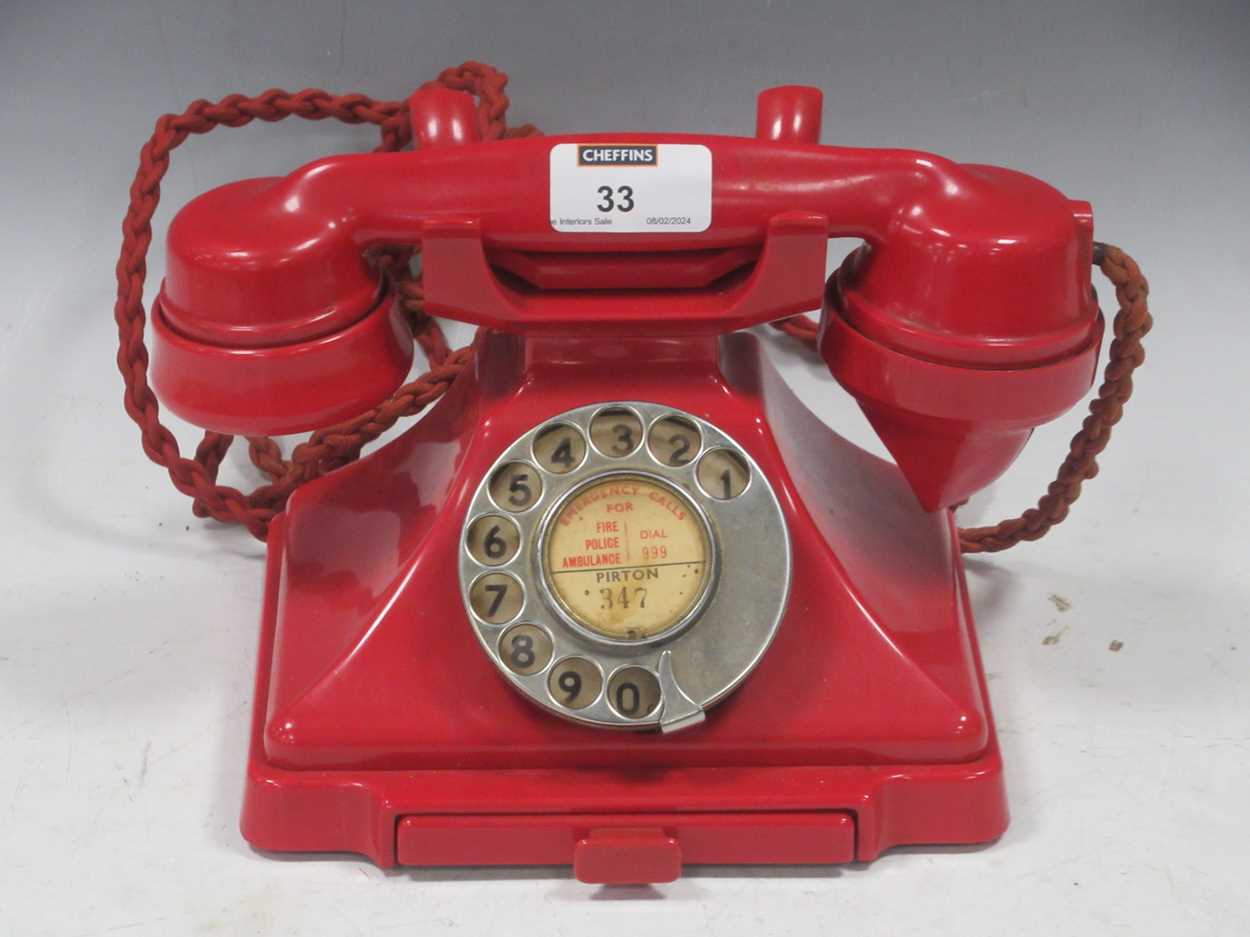 Lot 33 - Vintage red bakelite case telephone with