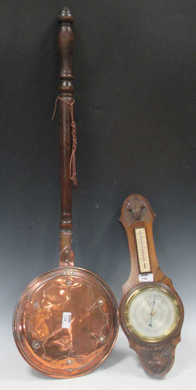 Lot 158 - An oak barometer 50cm high and a warming pan