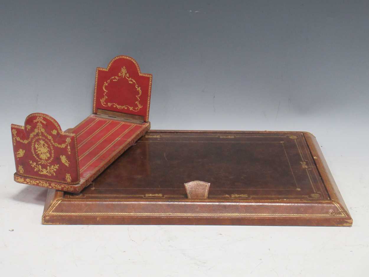 Lot 28 - An embossed leather desk blotter; book stand: