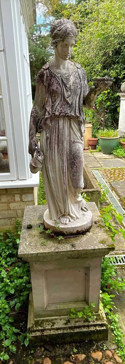 Lot 834 - A reconstituted stone garden statue of Hebe