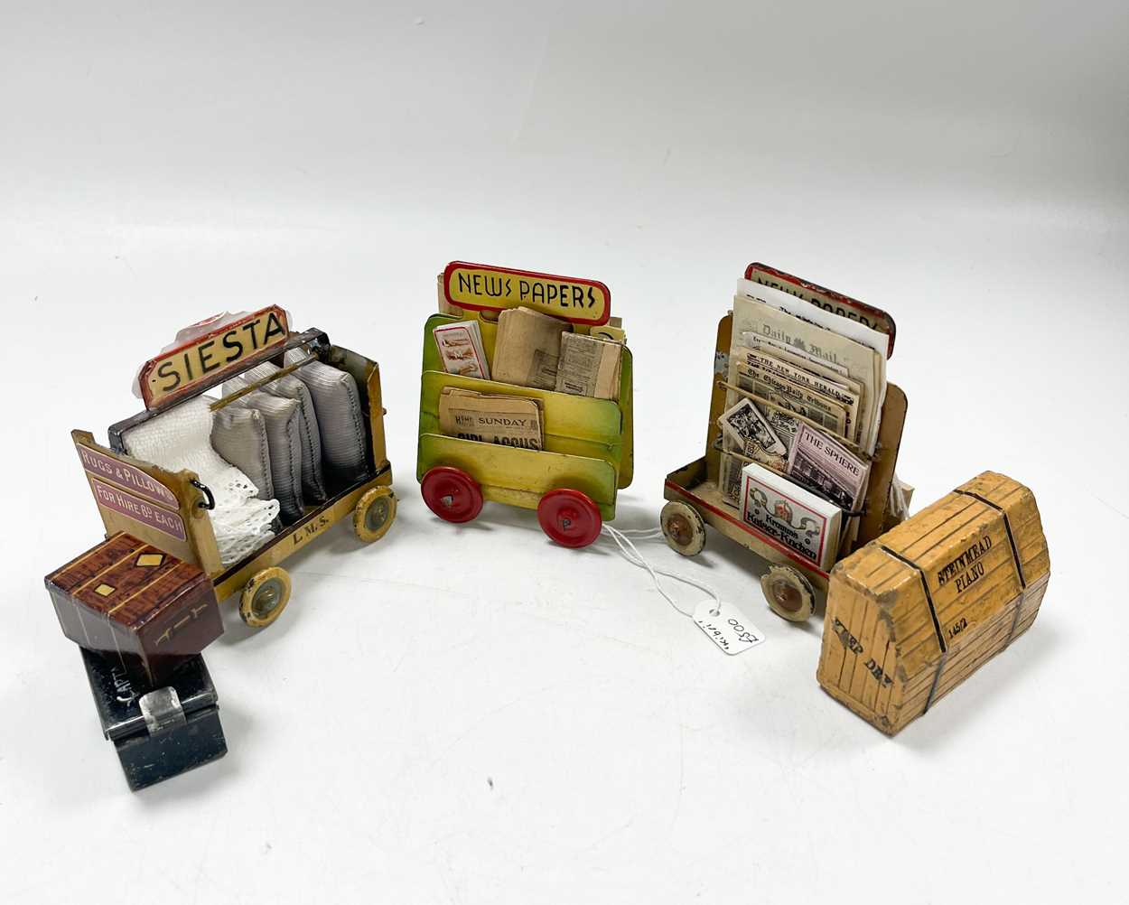 Lot 19 - Two dolls' newspaper cart trollies,