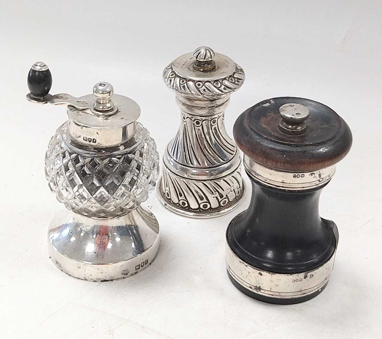 Lot 345 - A trio of silver pepper grinders; the first