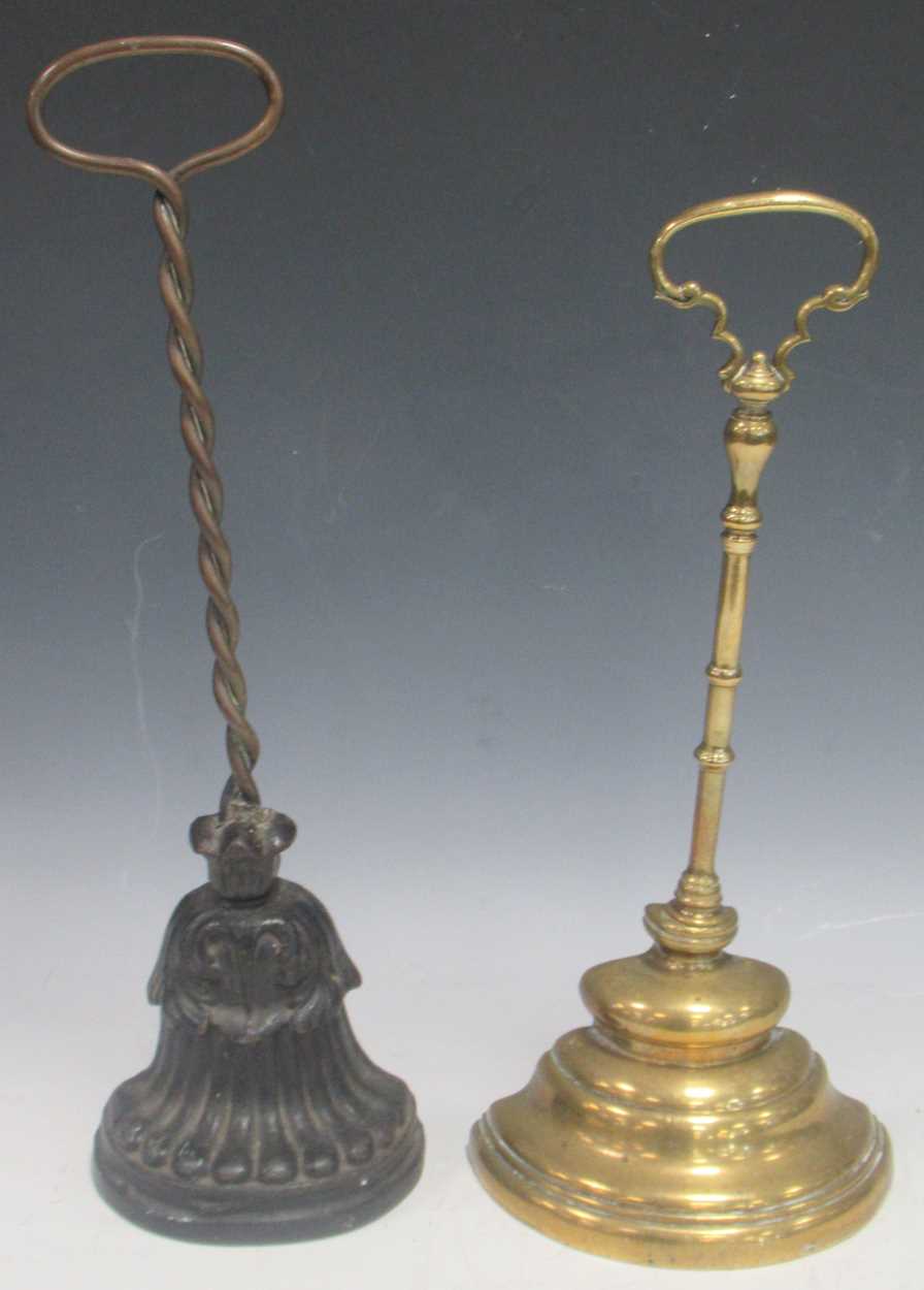 Lot 79 - Two 19th century stirrup doorstops, one brass