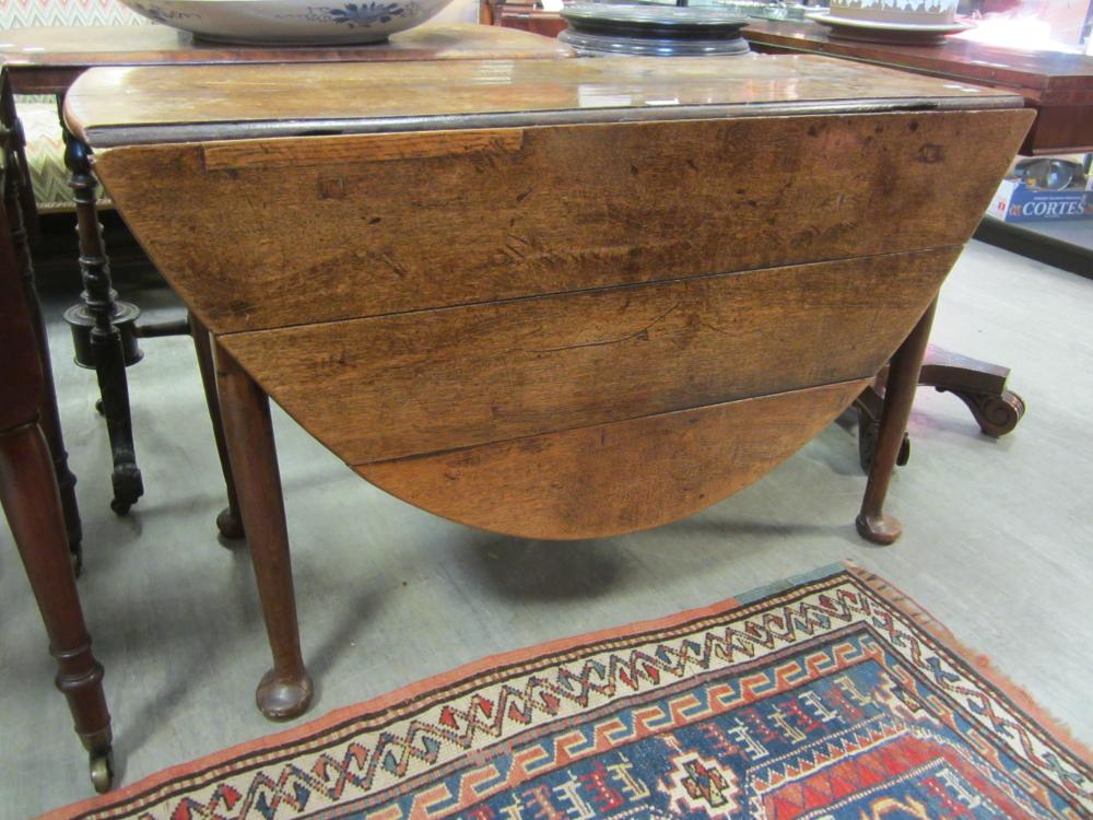 Lot 3 - An early 18th Century drop leaf dining table
